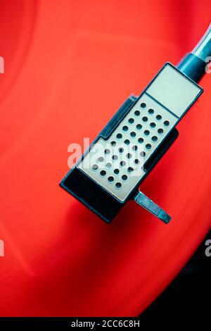 Red vinyl record playing on a turntable Stock Photo - Alamy