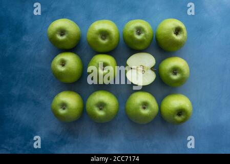 Bright green apples on blue background Stock Photo - Alamy