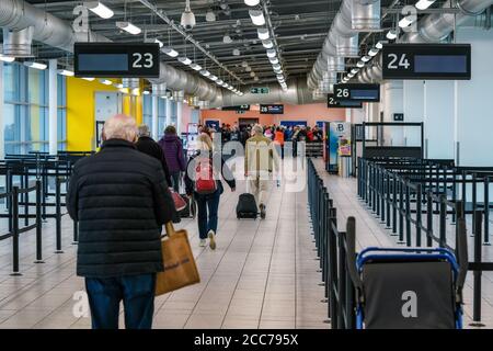 London Luton Airport, UK, check-in hall. Easyjet passengers queue to ...