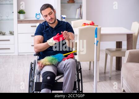 Young leg injured contractor in wheelchair cleaning the house Stock ...