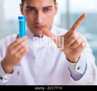 Young chemist pressing virtual buttons in lab Stock Photo - Alamy