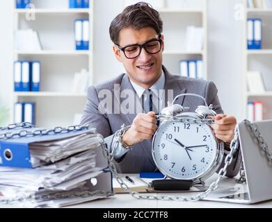 The busy employee chained to his office desk Stock Photo - Alamy