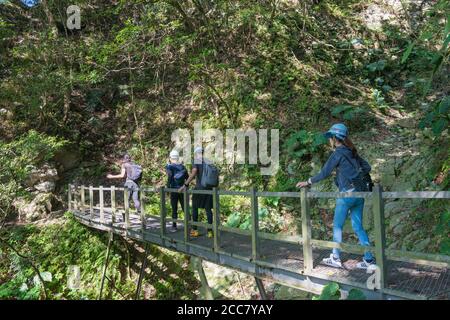 Hualien, Taiwan - Hikers at Zhuilu Old Road in Taroko National Park ...