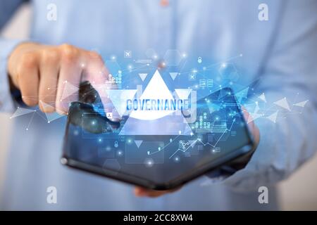 Businessman holding a foldable smartphone, business concept Stock Photo ...
