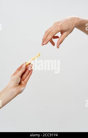 Hand passes burger on blue background with orange circle . Artistic ...