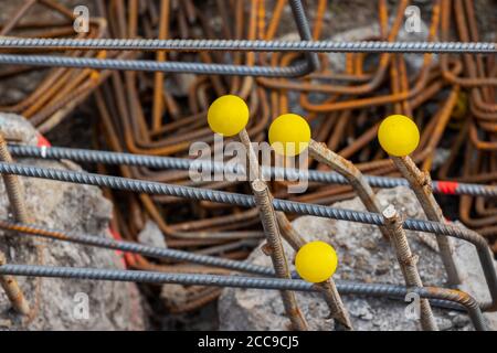 rebar caps on rebar at construction site for safety Stock Photo - Alamy