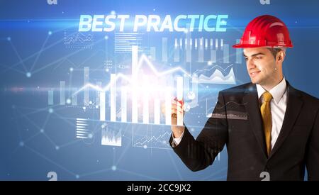 Handsome businessman with helmet drawing BEST PRACTICE inscription ...