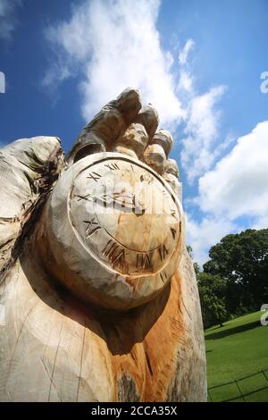 Reaching for the clock. Hold on to the passing time. Hand and big clock ...