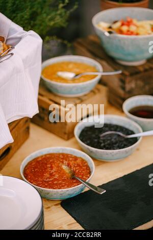 Wooden plate with different sauces on table Stock Photo - Alamy