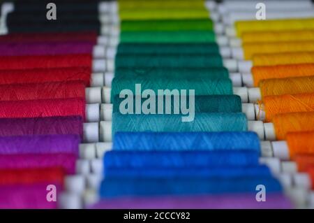 colourful thread rolls arranged in a box. Some parts of the image are ...