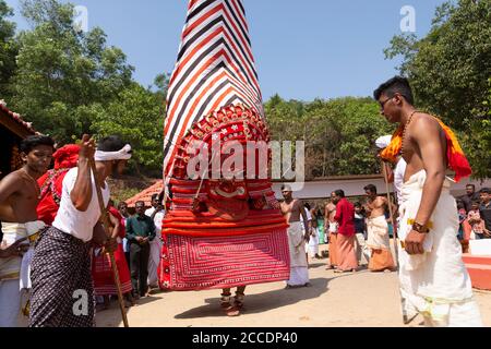 Traditional Theyyam performer adorned in elaborate costume and makeup ...