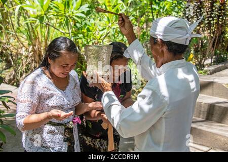 Holy water pouring ceremony over bride and groom hands, Thai ...