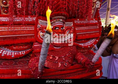 Traditional Theyyam performer adorned in elaborate costume and makeup ...