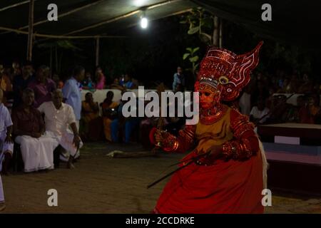 Traditional Theyyam performer adorned in elaborate costume and makeup ...