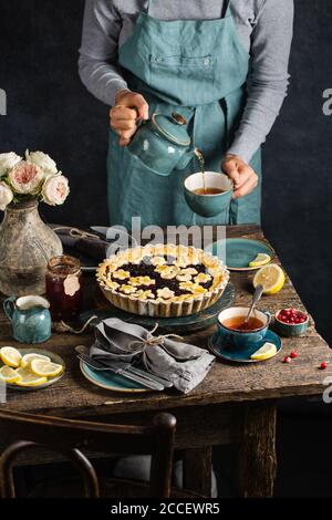 Tea party at the autumn tablewith whith berry pie and a cup of hot tea ...