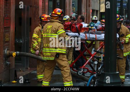 Fire company works to put out fire in NYC building Stock Photo - Alamy