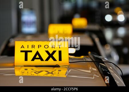 Airport Taxi sign illuminated at night Stock Photo - Alamy