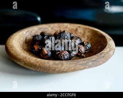 Sapindus rarak on wood plate with white background Stock Photo - Alamy