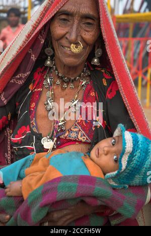 Indian nomad woman with baby, in the Thar desert near Jaisalmer ...