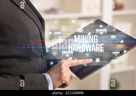 Close-up of a tablet searching MINING HARDWARE inscription, modern ...