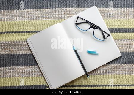 top view of opened blank notebook and math education numbers on pink ...