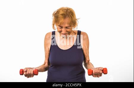 Senior Woman Straining With Lifting Dumbbells While Wearing A Face Mask ...