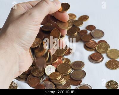 Hand handing Euro coins money (EUR), currency of European Union Stock ...