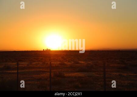 A dust storm covers the setting sun along the california border Stock ...