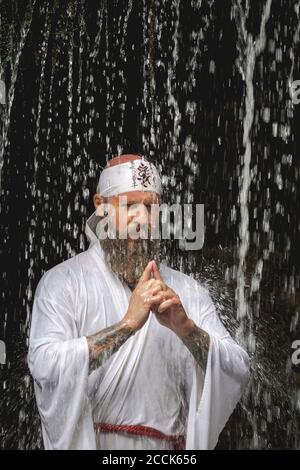 European yamabushi monk doing takigyo waterfall meditation Stock Photo ...