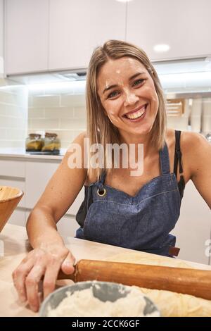happy woman in apron with rolling pin in kitchen Stock Photo - Alamy