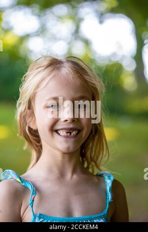 Portrait of cute girl smiling with gap-toothed grin, missing her baby ...