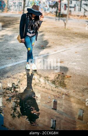 Mixed race woman standing on beach on a sunny day Stock Photo - Alamy