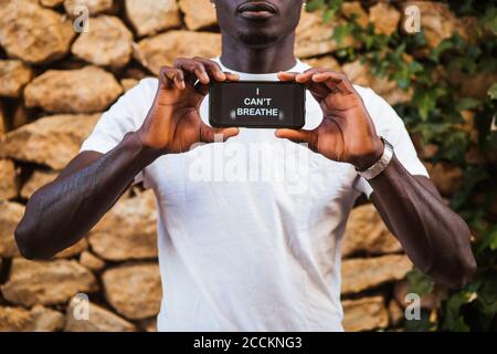 close up of man with smartphone at stone wall Stock Photo - Alamy
