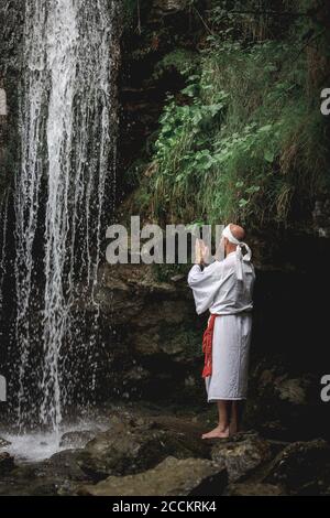 European yamabushi monk doing takigyo waterfall meditation Stock Photo ...
