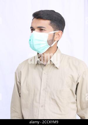 Cute Indian boy wearing surgical mask showing thumbs up or all done or ...