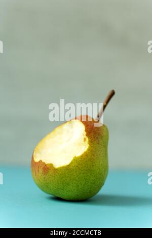 Bitten green pear on a white background. close up Stock Photo - Alamy
