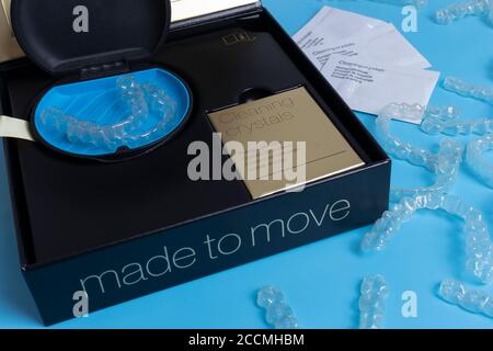 Invisalign transparent brackets package box on blue background with ...