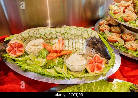 served whole fish with the help of vegetables Stock Photo - Alamy