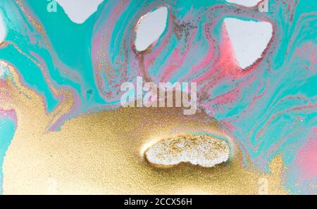 Piles of gold sequins on pink smudges of paint. Abstract pattern Stock ...