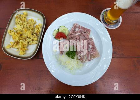 Brawn with fried potatoes and wheat beer on a beer table, Franconia ...