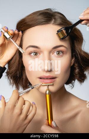 Dark-haired young woman demonstrating a pink blouse online Stock Photo ...