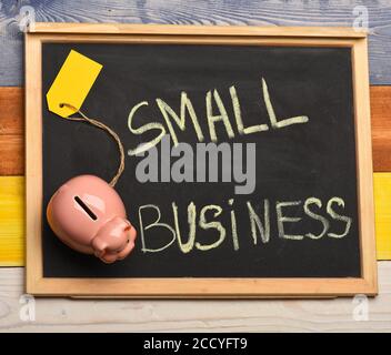 The inscription SALE is written on a blackboard. happy girl jumps ...