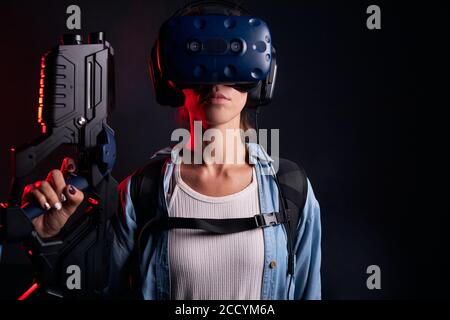 Isolated shoot of young woman gaming with VR weapon, speacial mask on ...
