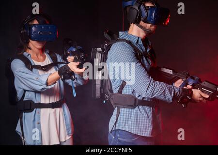 Lovely couple playing vr game as team, fighting. Wearing casial clothes ...