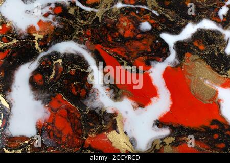 Red, black, white and gold paint liquid background. Abstract marble ...