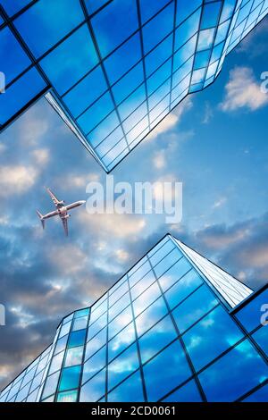 airplane flying between buildings Stock Photo - Alamy