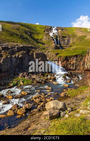 View of Rjukandi waterfalls also called Yst i-Rjukandi with cliffs and ...