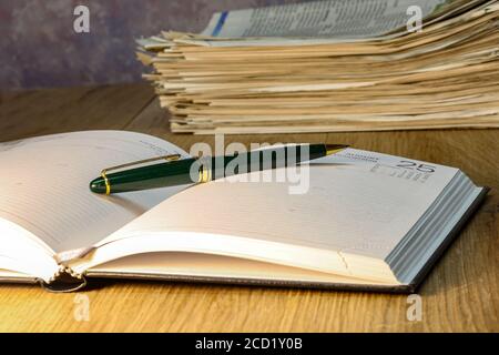 Pen lying on calendar or organizer on desk in office Stock Photo - Alamy