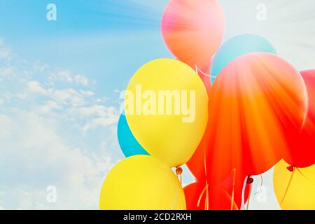 Colorful balloons inflated against the sun, festive and joyful colorful ...