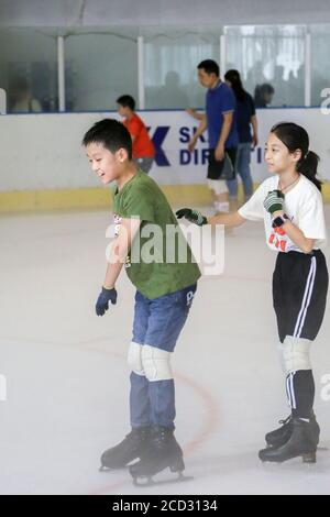 Citizens enjoy skating at an indoor ice rink to relieve scorching ...
